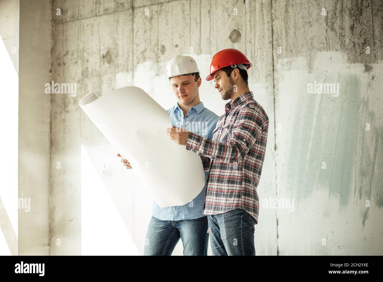 talented, creative engineer is showing the plan of object to a client ...