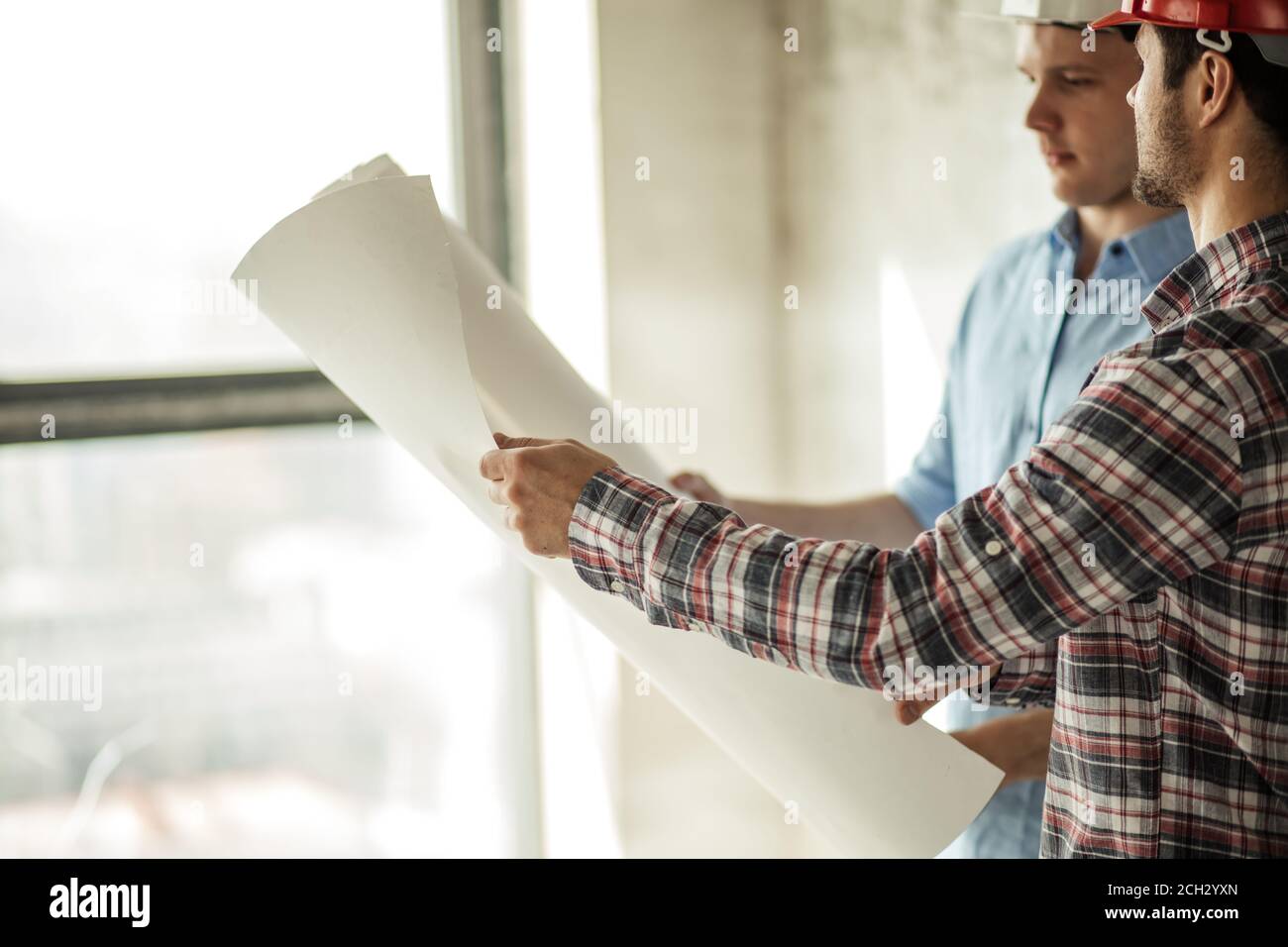 close up cropped photo. two designers are working on the blueprint ...