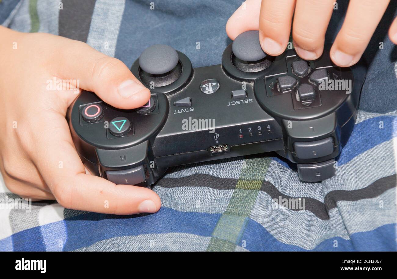 hands holding a dark-colored Game console Stock Photo - Alamy