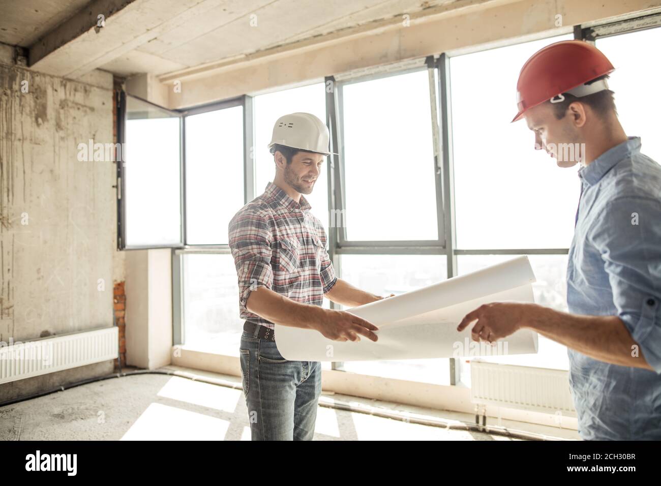 talented engineer is handing in a plan of construction to a chief. side ...