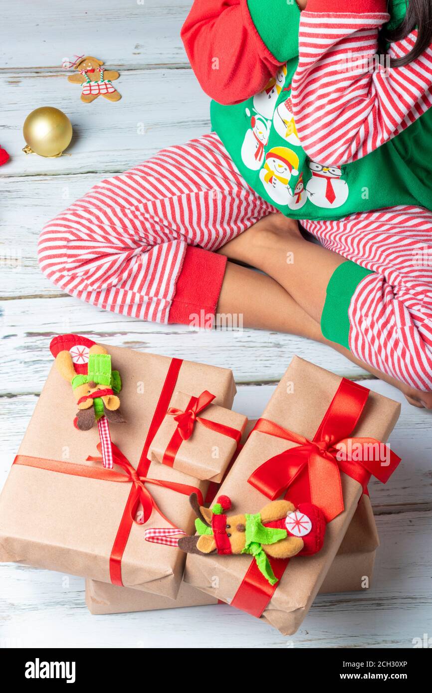 Cute brunette girl with her presents on Christmas day Stock Photo - Alamy