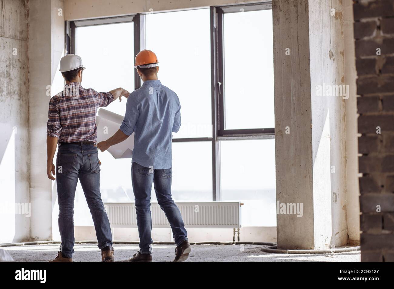 engineer is showing the execution of building project to a customer ...