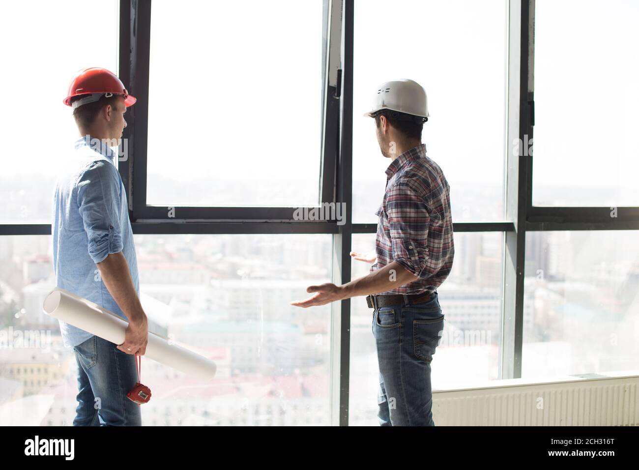 creative teem engineers looking at the panorama window. back view photo ...