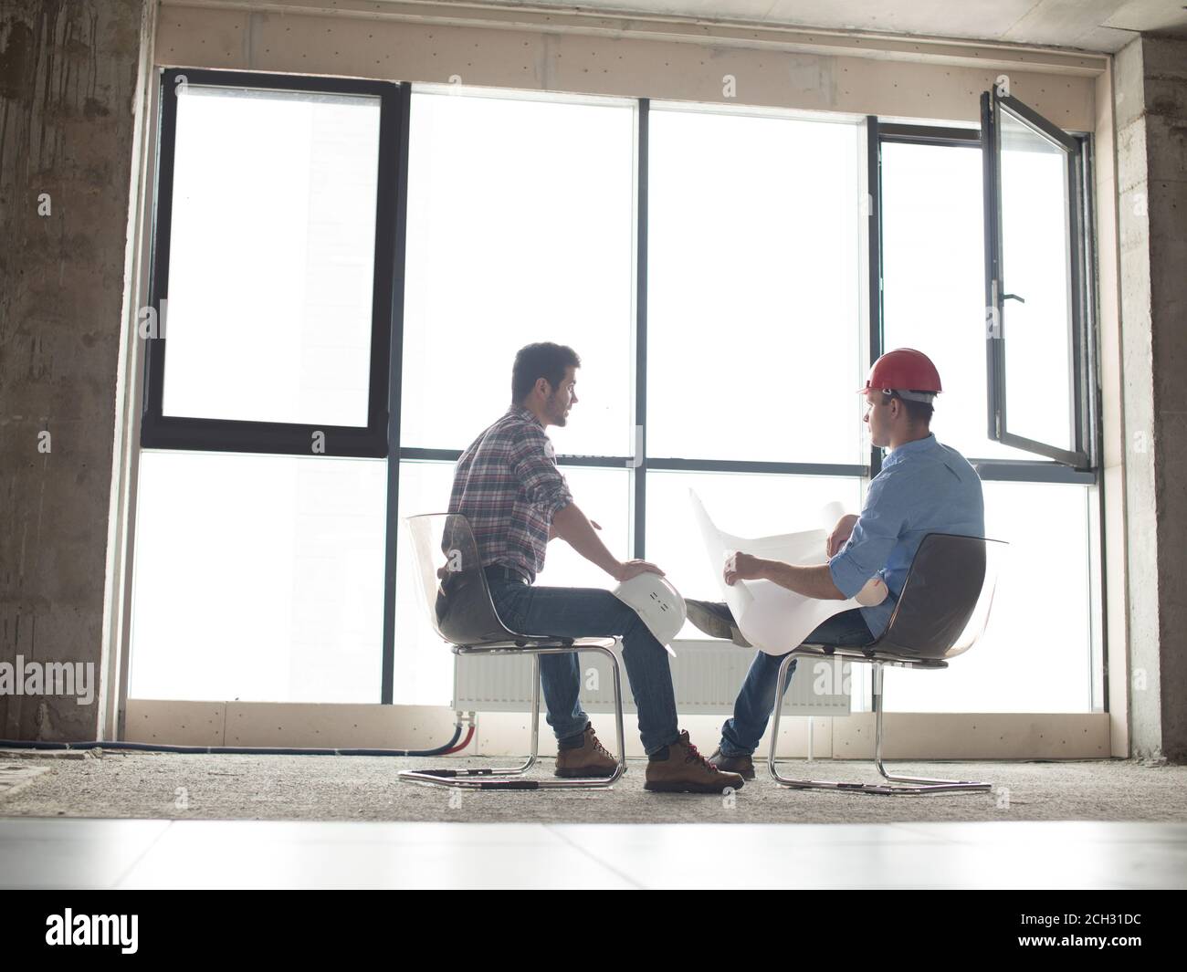 construction worker is offering co-operation to a friend. full length ...