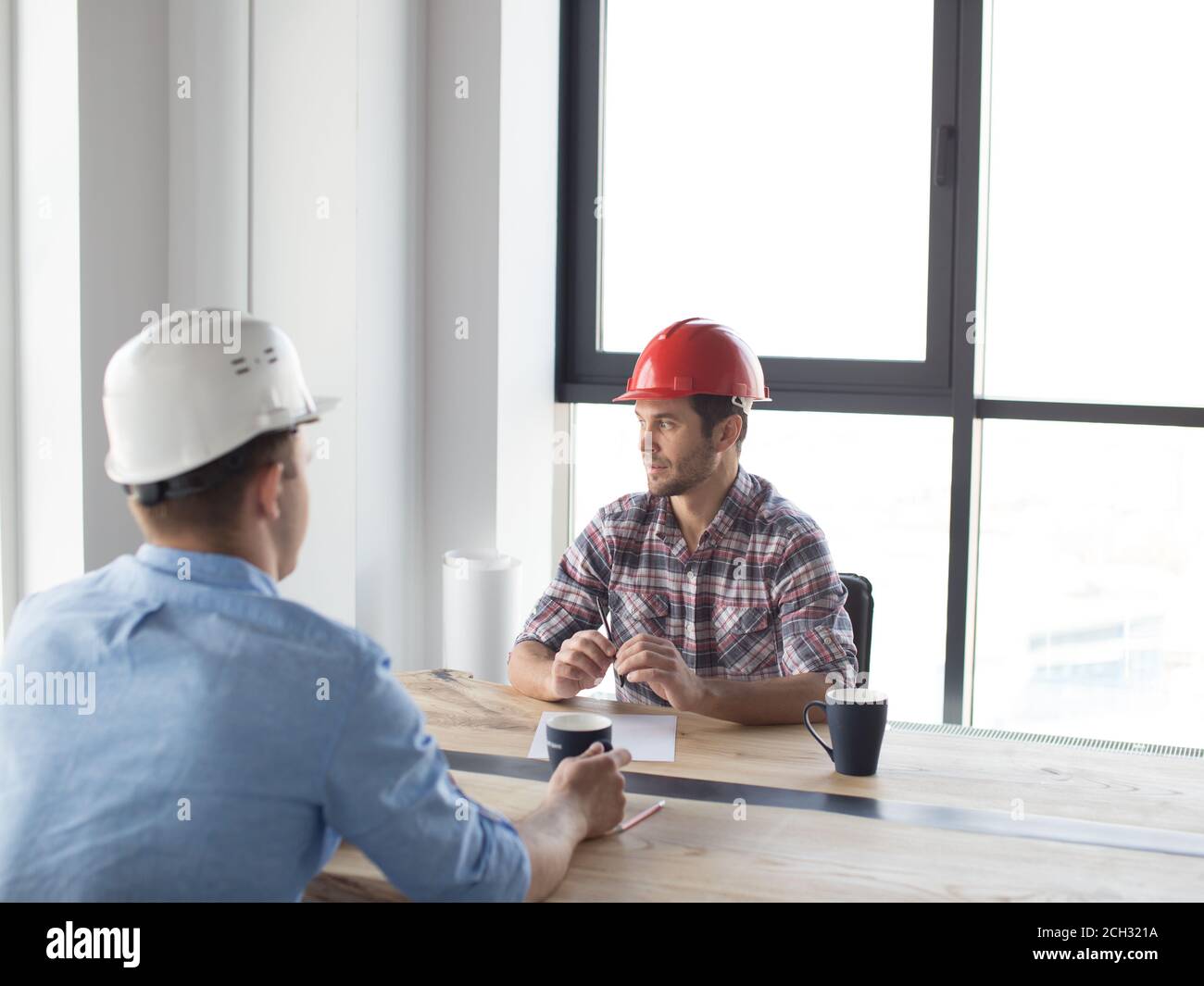 two people talking business over coffee in the office room with ...