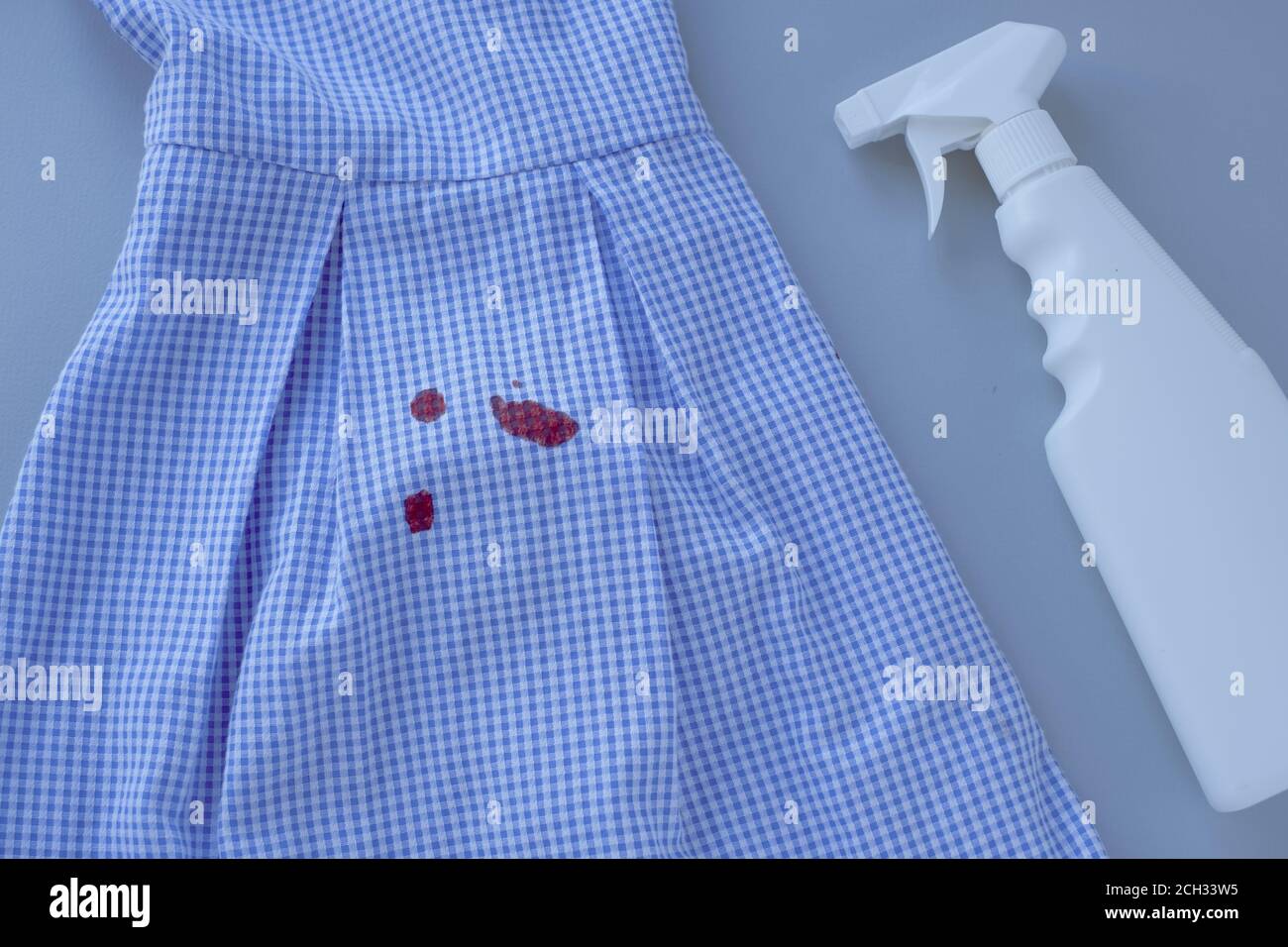 dirty blood stains on dress and stain remover.isolated on gray ...