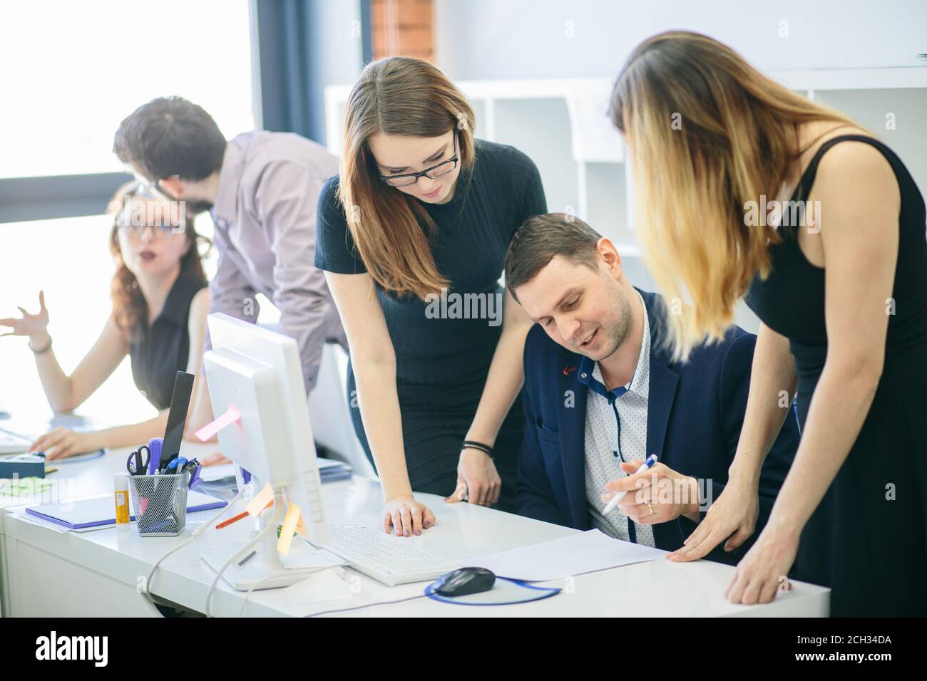 close up portrait of CEO sitting among his employees and showing them ...