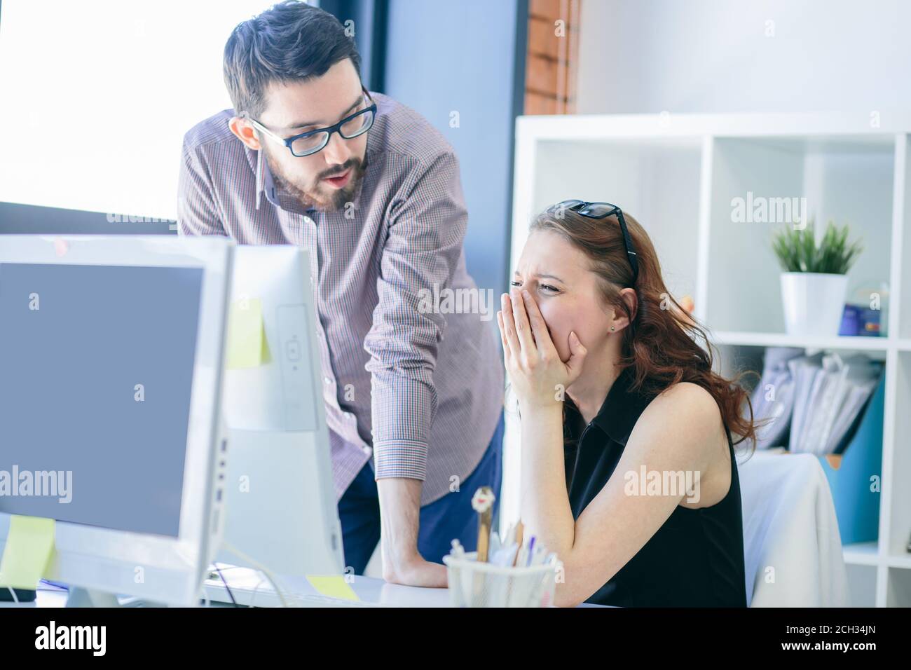 crying secretary is closing her face while handsome partner is trying ...