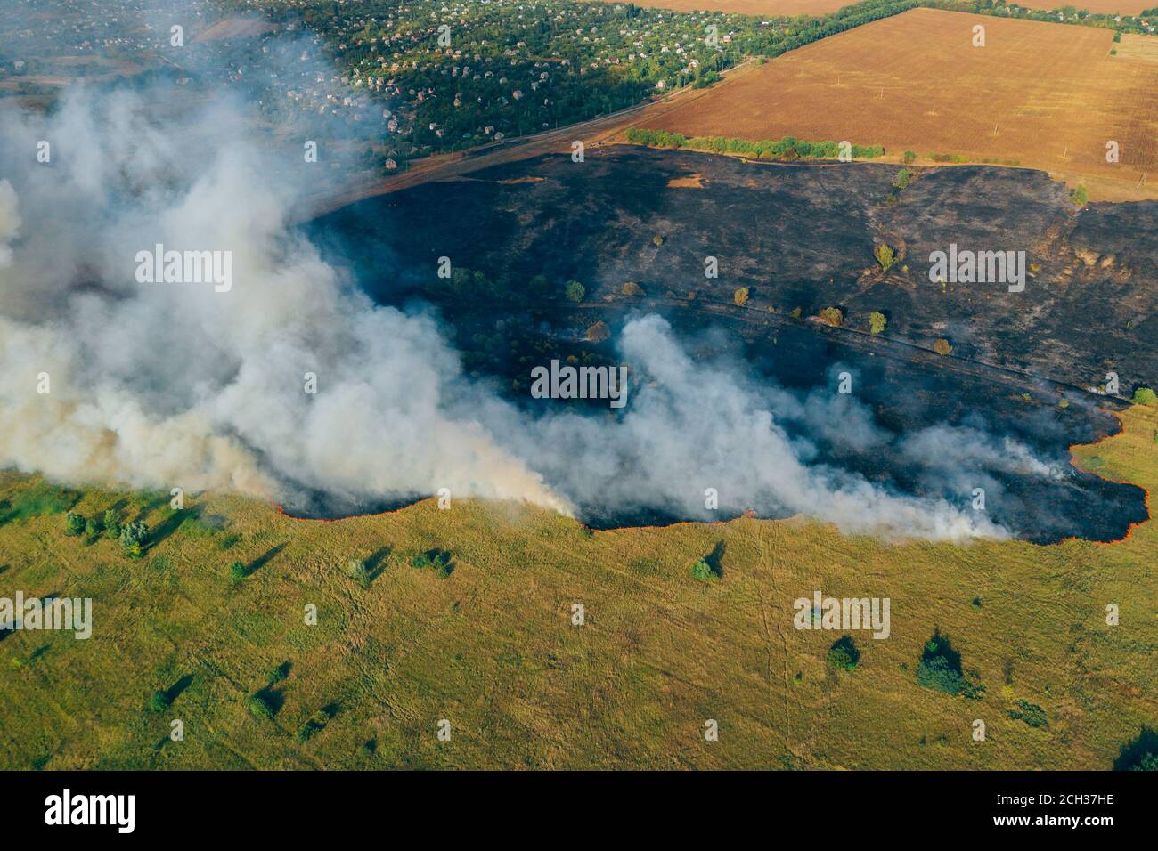 Clouds of smoke above dry burning field, natural disaster wildfire ...