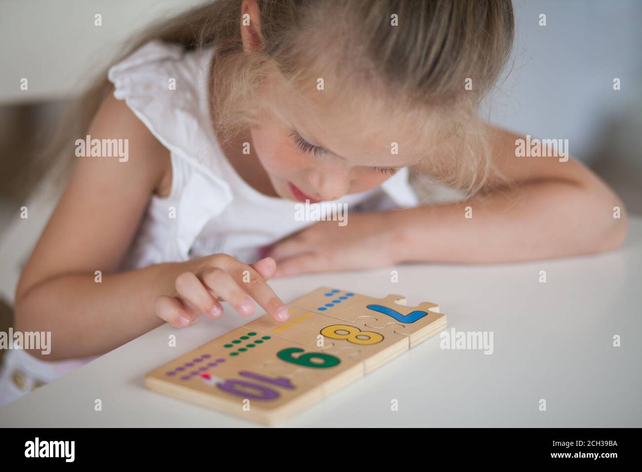 Little cute preschooler child girl playing educational games with ...