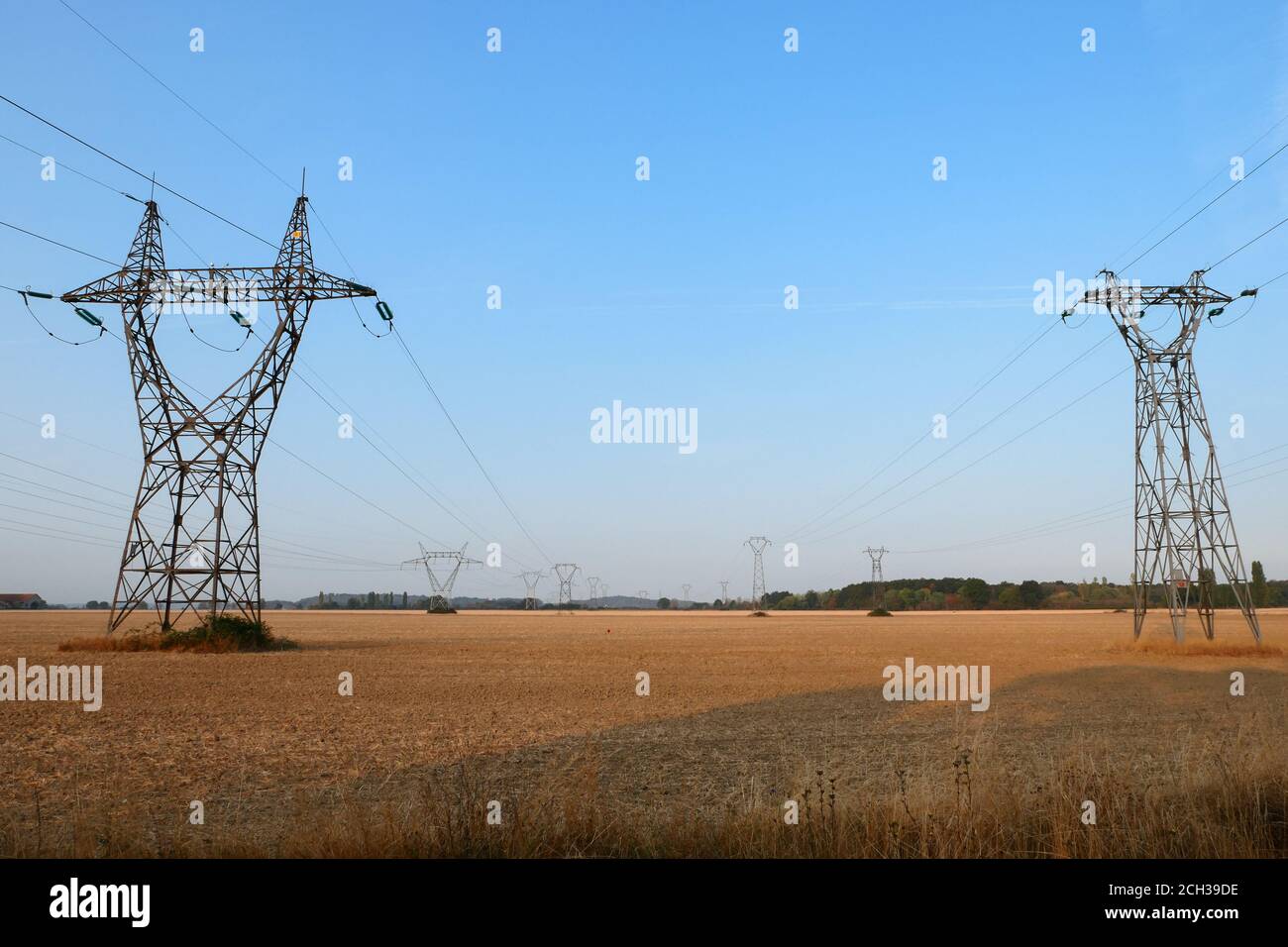 Group of electric pylons, high voltage lines. Overhead cables carrying ...