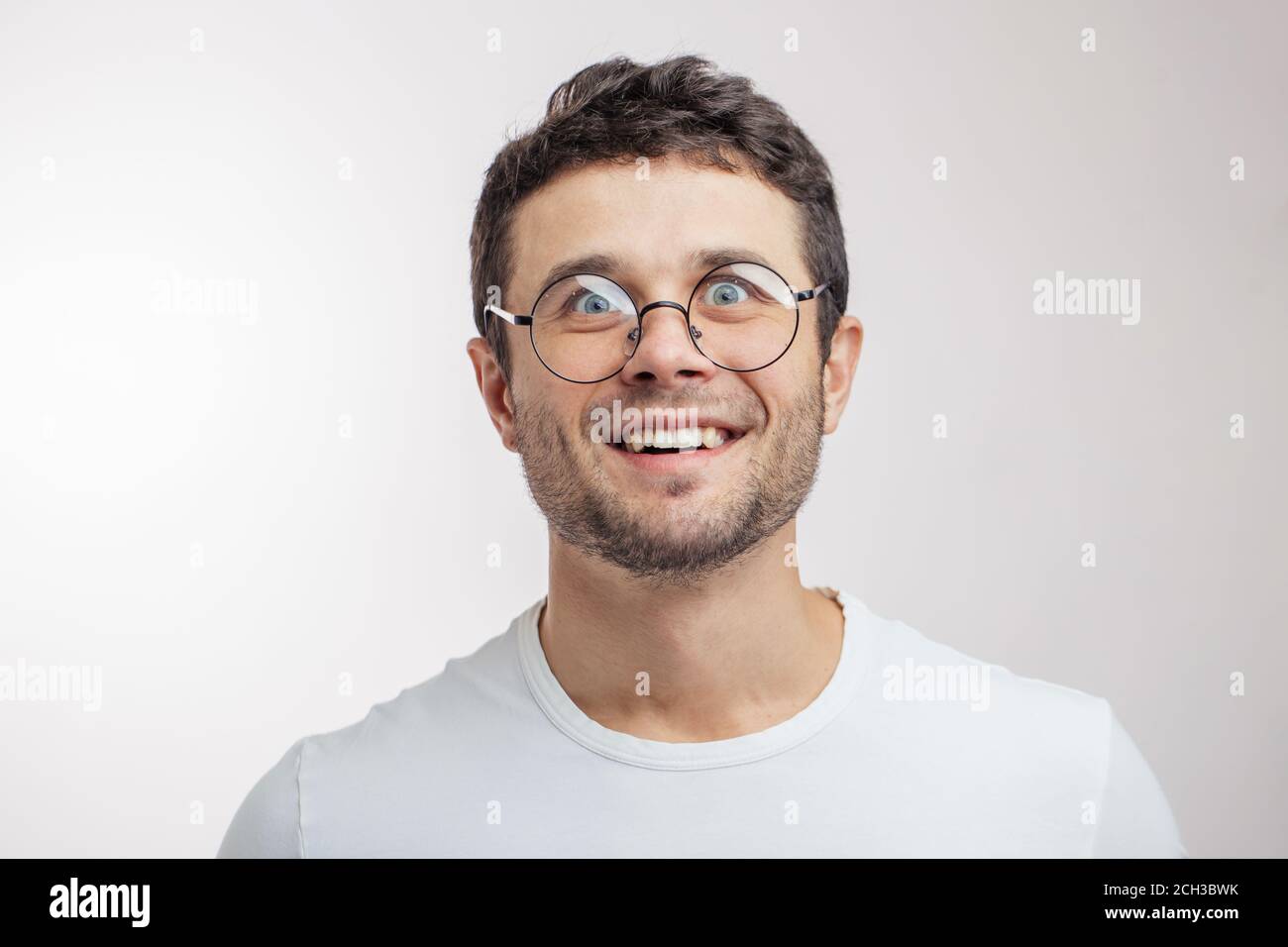 a man of feeling. sentimental guy is watching TV with enthusiastic eyes ...