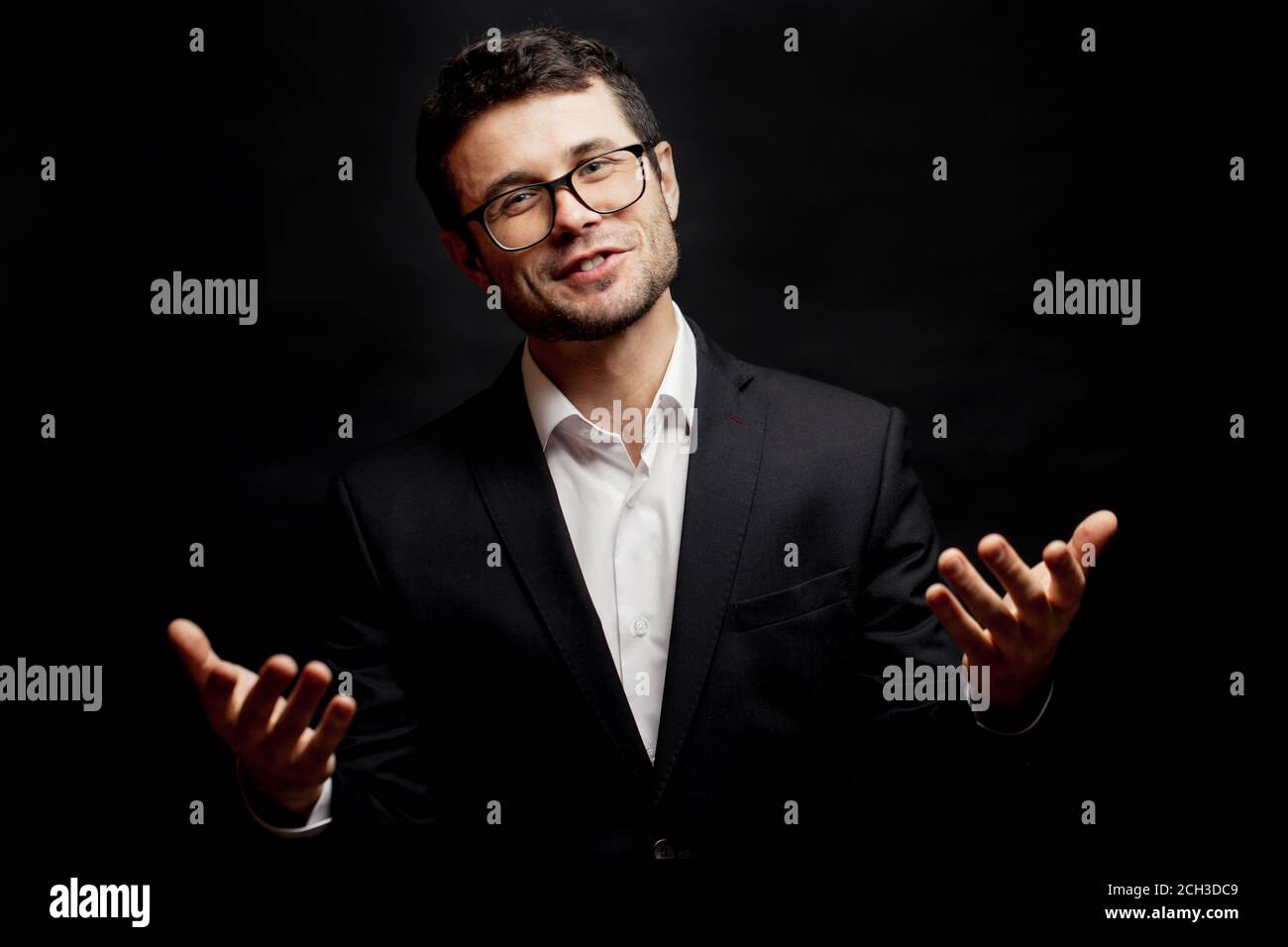 cheerful young ambitious man dressed formally extending a warm welcome ...