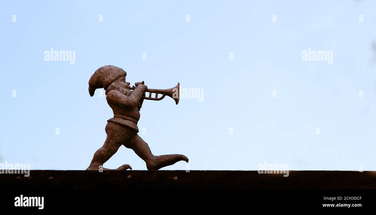 dwarf playing a trumpet in front of blue sky Stock Photo - Alamy