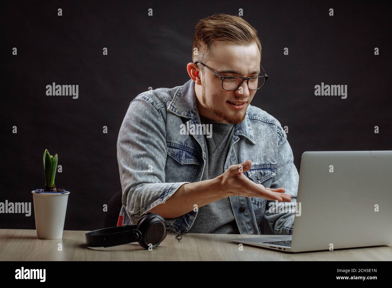 ginger cheerful man showing to the screen of the laptop. what has ...