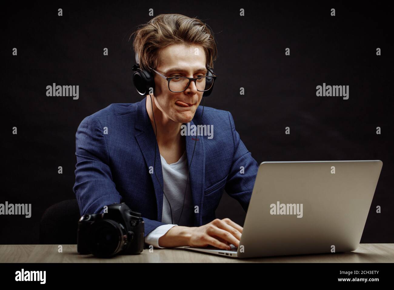 photo designer with surprised, puzzled look at workplace Stock Photo ...