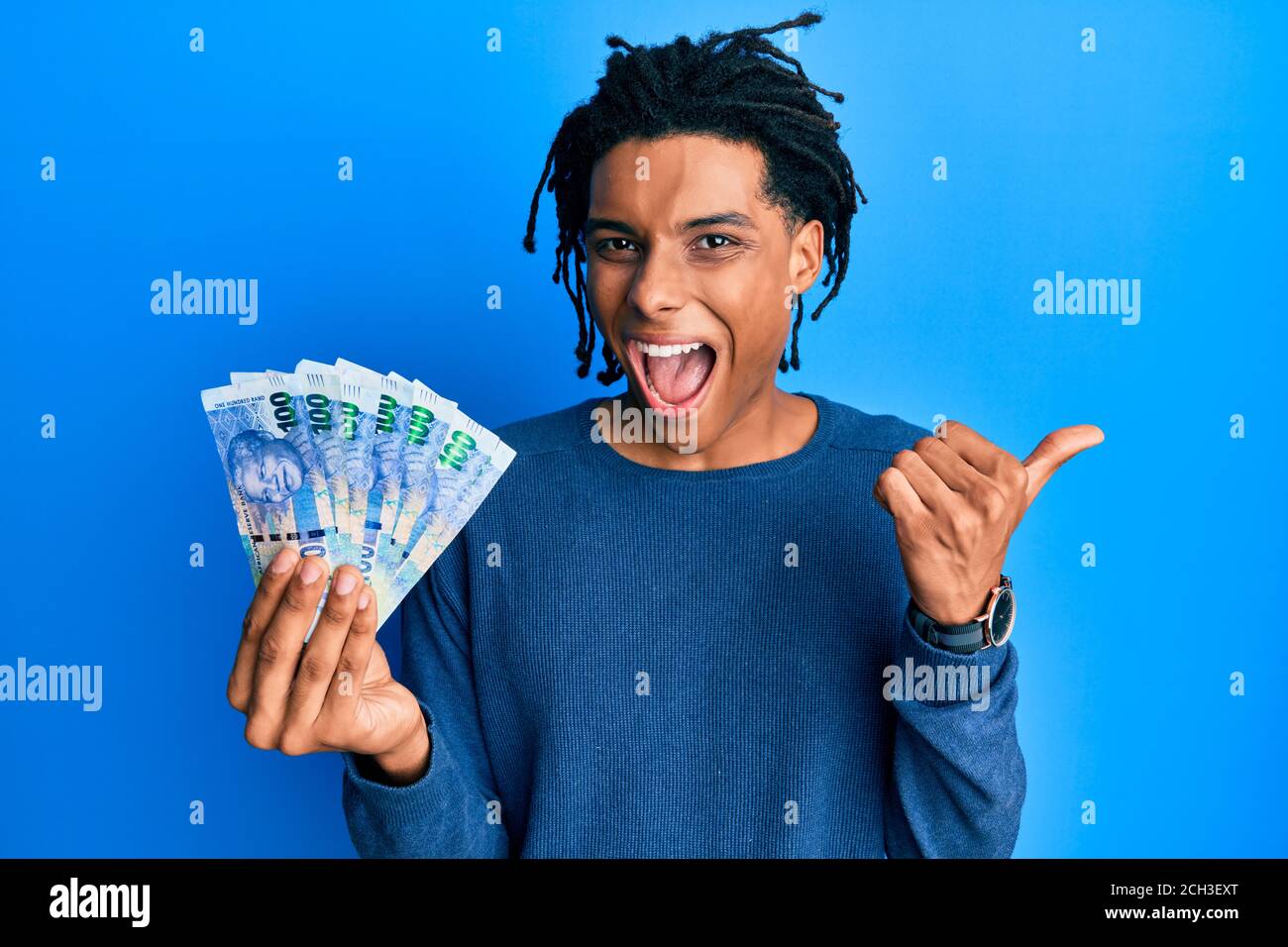 Young african american man holding south african 100 rand banknotes ...