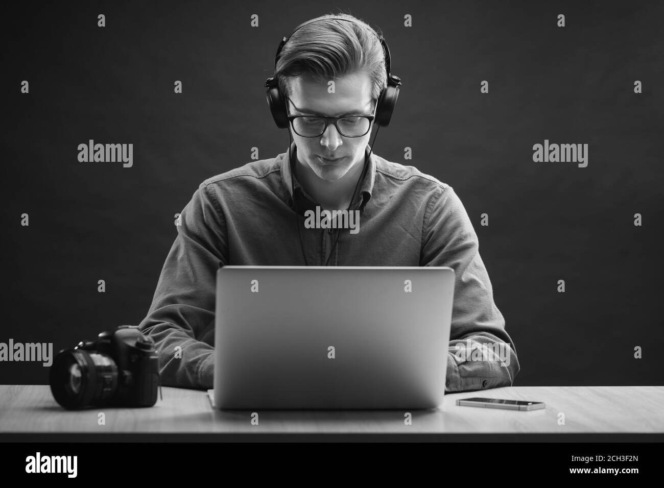 black and white photo. close up portrait of photographer working in ...