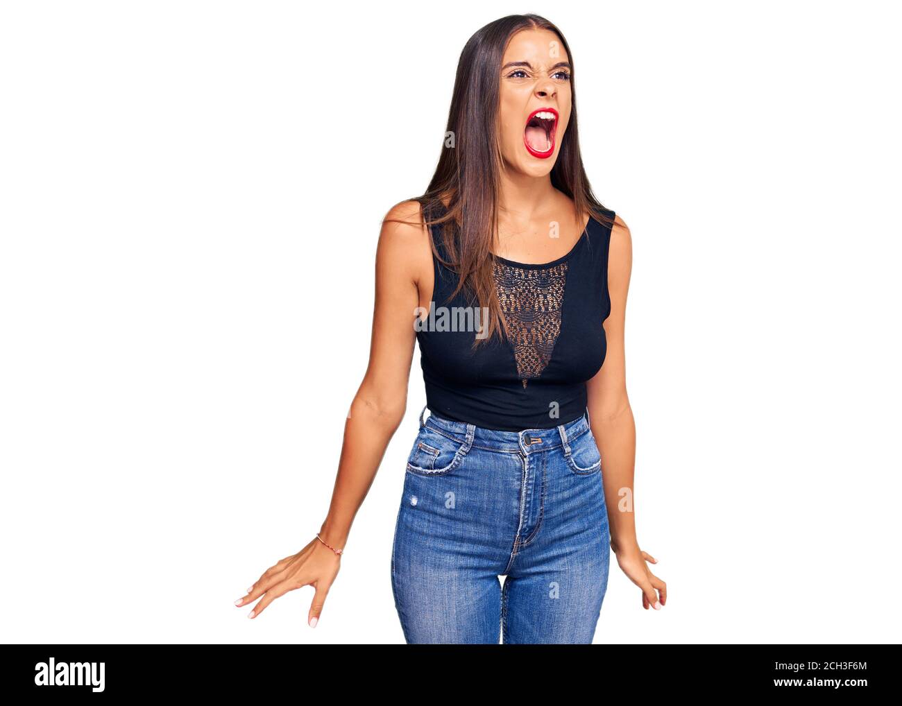 Young hispanic woman wearing casual clothes angry and mad screaming ...