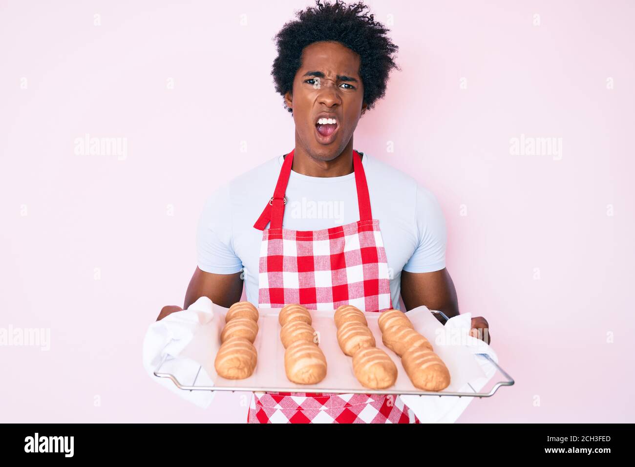 Handsome african american man with afro hair wearing baker uniform ...