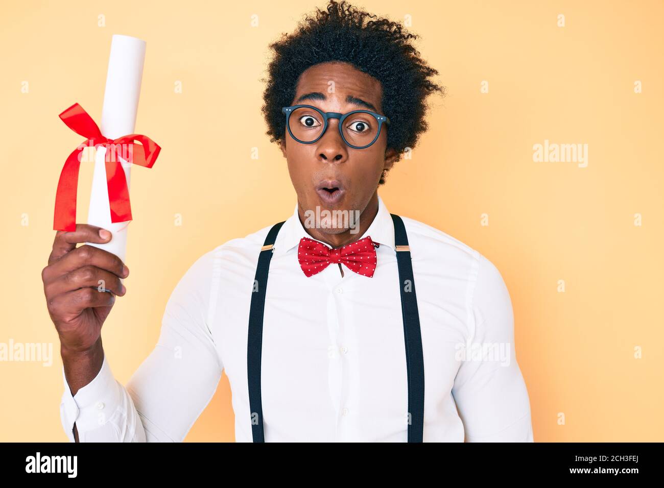 Handsome african american nerd man with afro hair holding graduate ...
