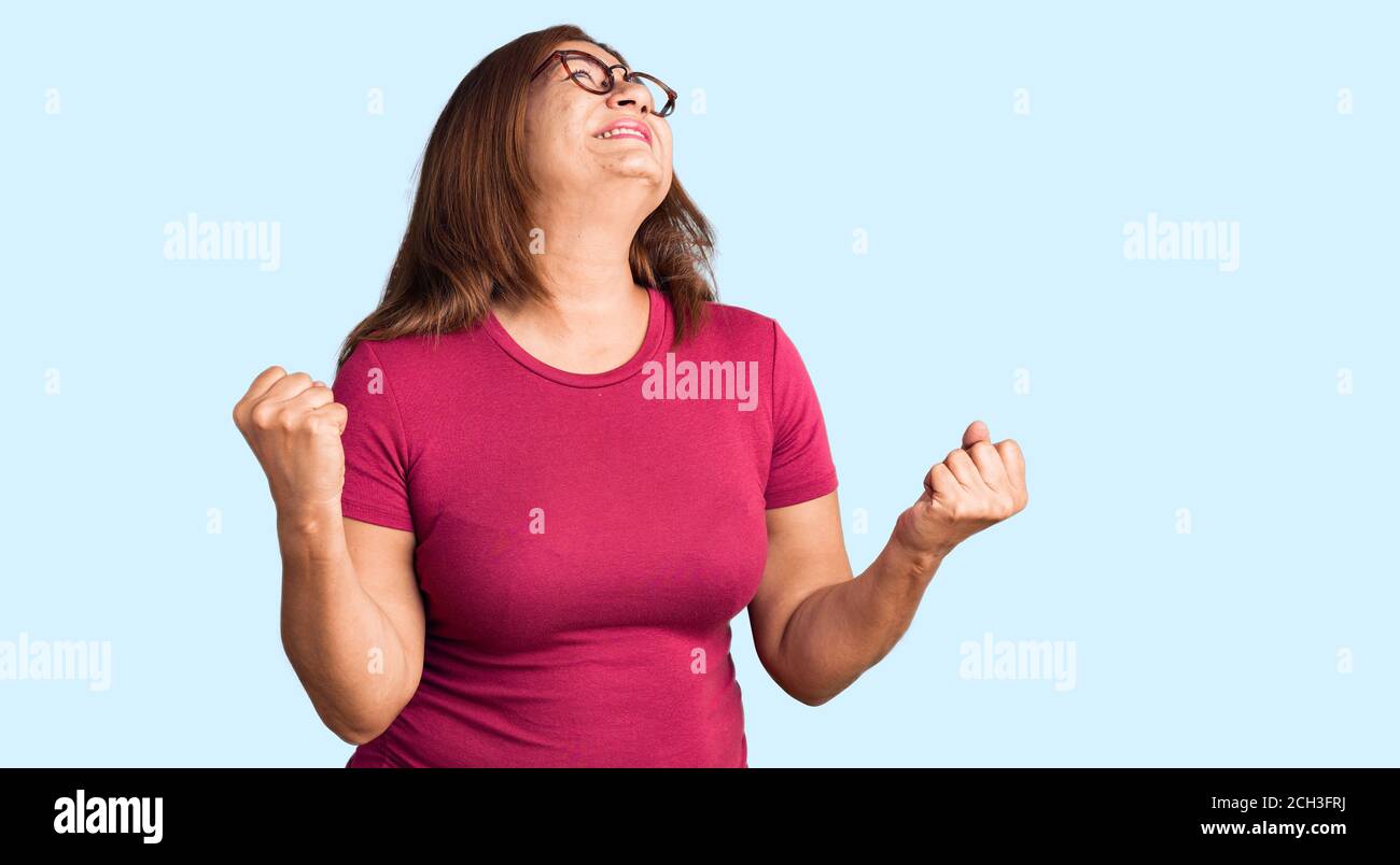 Middle age latin woman wearing casual clothes and glasses very happy ...