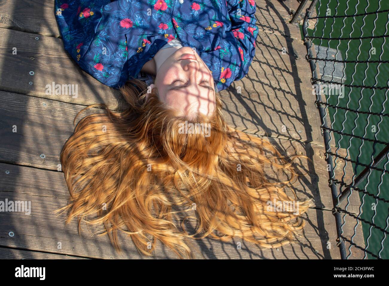 Photo session Freedom. Girl on the bridge with a grid of shadows Stock ...