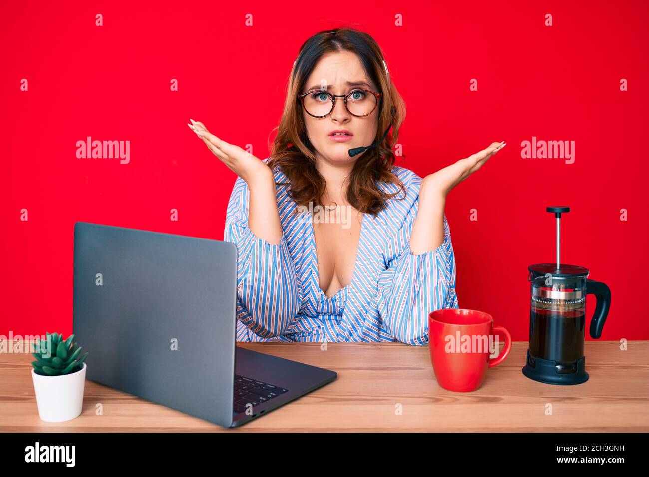 Young beautiful caucasian woman working at the office wearing operator ...