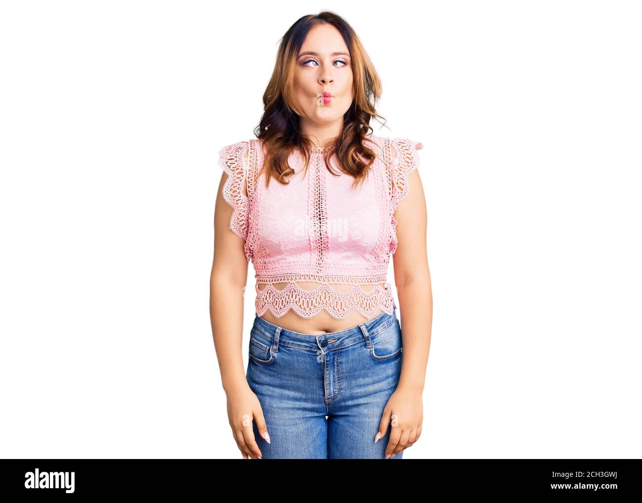 Young beautiful caucasian woman wearing casual clothes making fish face ...