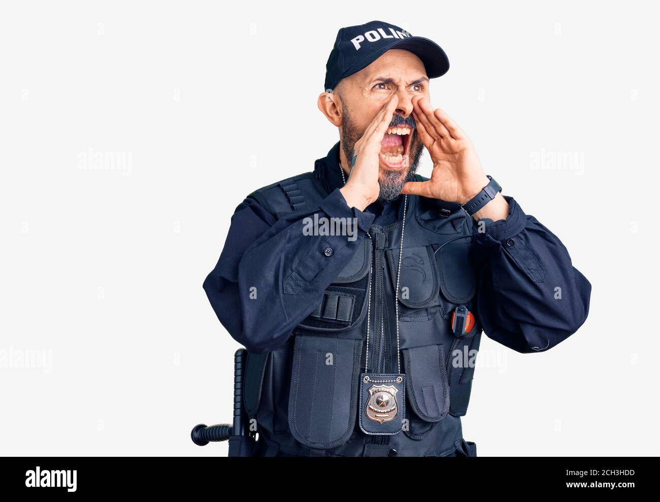 Young handsome man wearing police uniform shouting angry out loud with ...