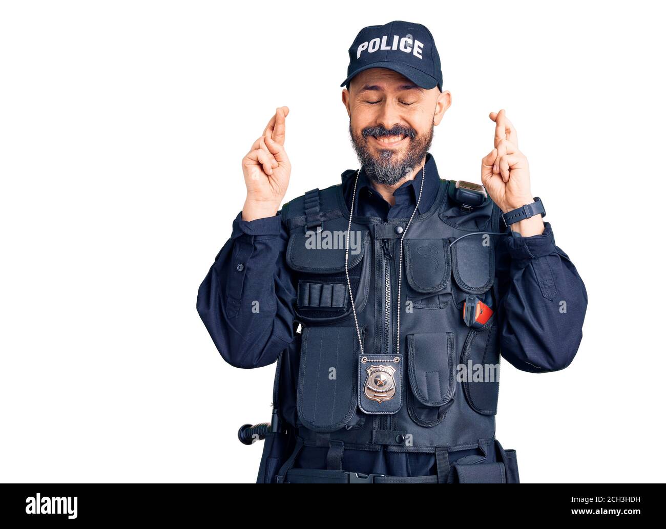 Young handsome man wearing police uniform gesturing finger crossed ...