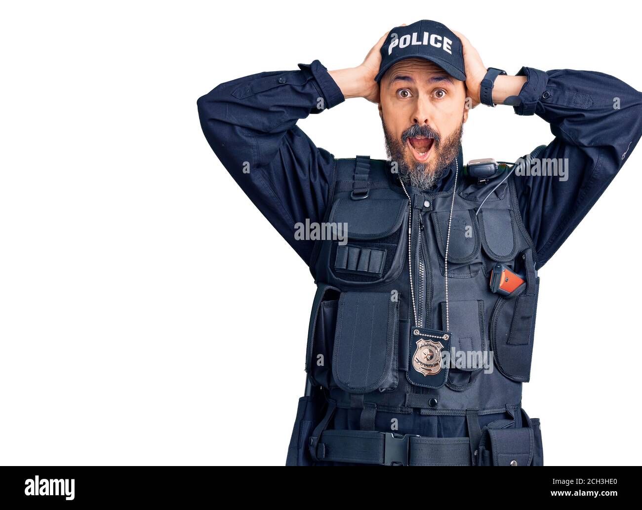 Young handsome man wearing police uniform crazy and scared with hands ...