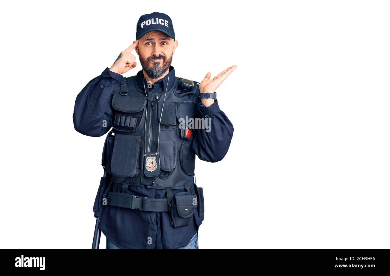 Young handsome man wearing police uniform confused and annoyed with ...