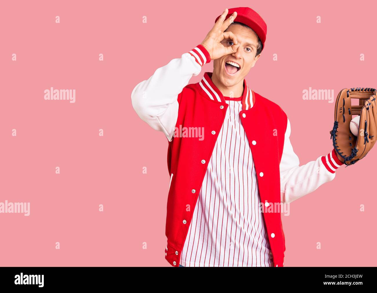 Young handsome man wearing baseball uniform holding golve and ball ...