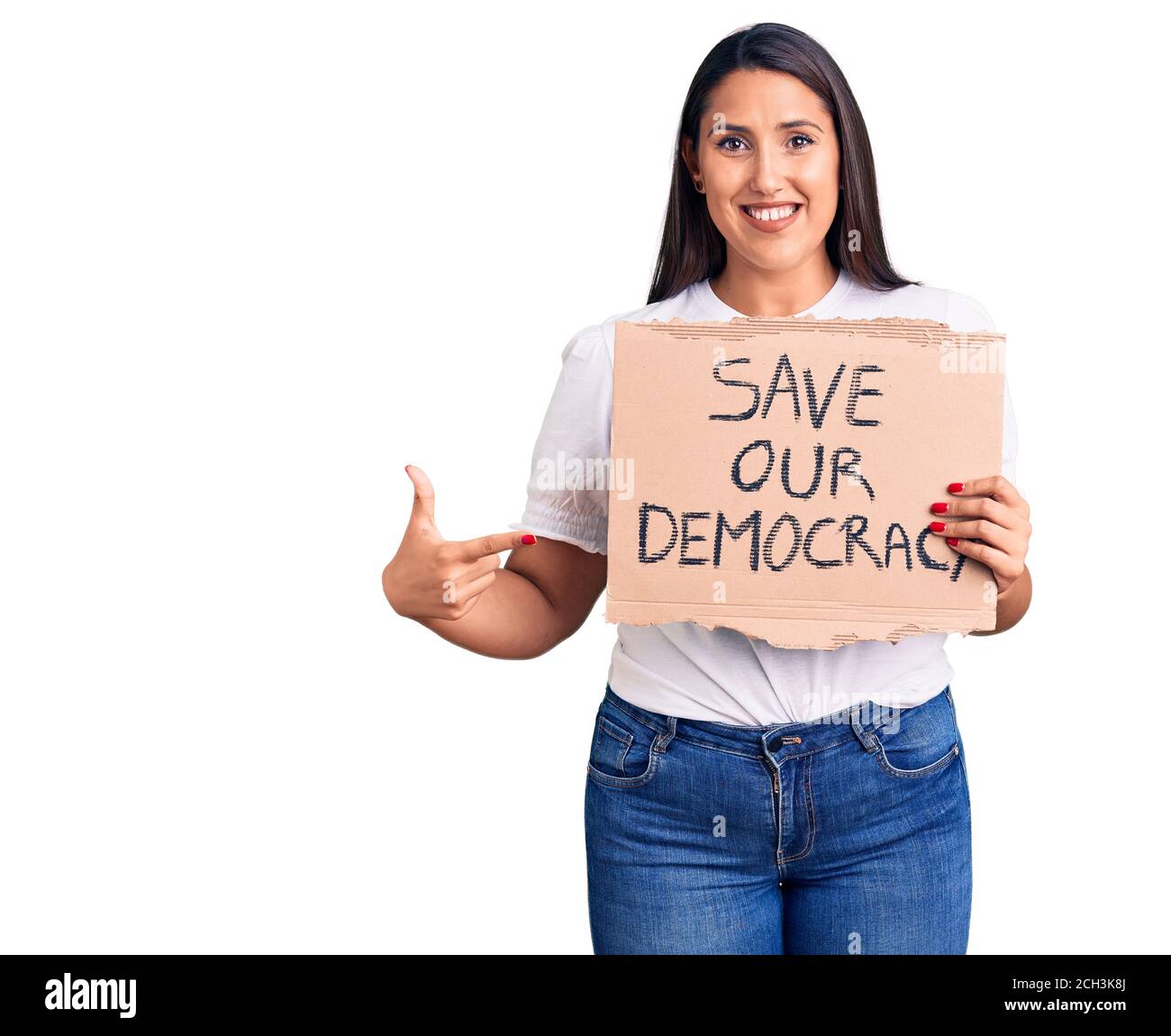 Young beautiful woman holding save our democracy cardboard banner ...