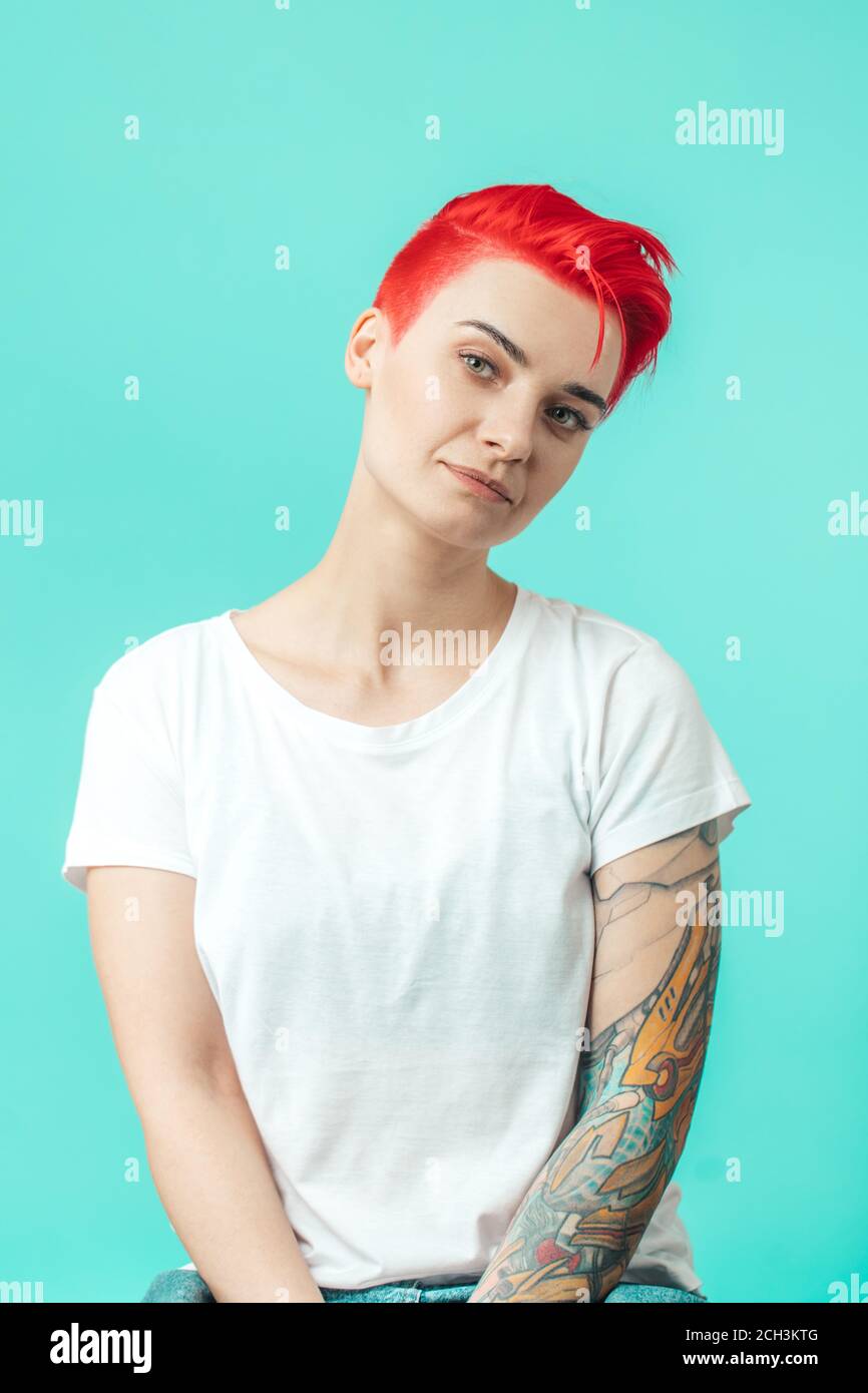 exotic girl in white T-shirt is looking at the camera. isolated blue ...