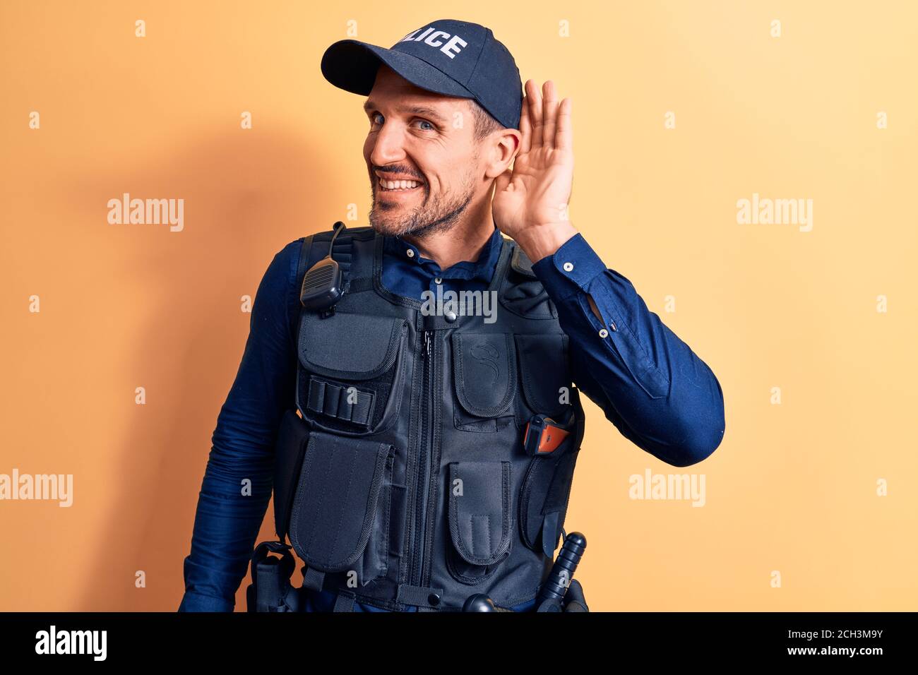 Young handsome policeman wearing police uniform and bulletprof over ...