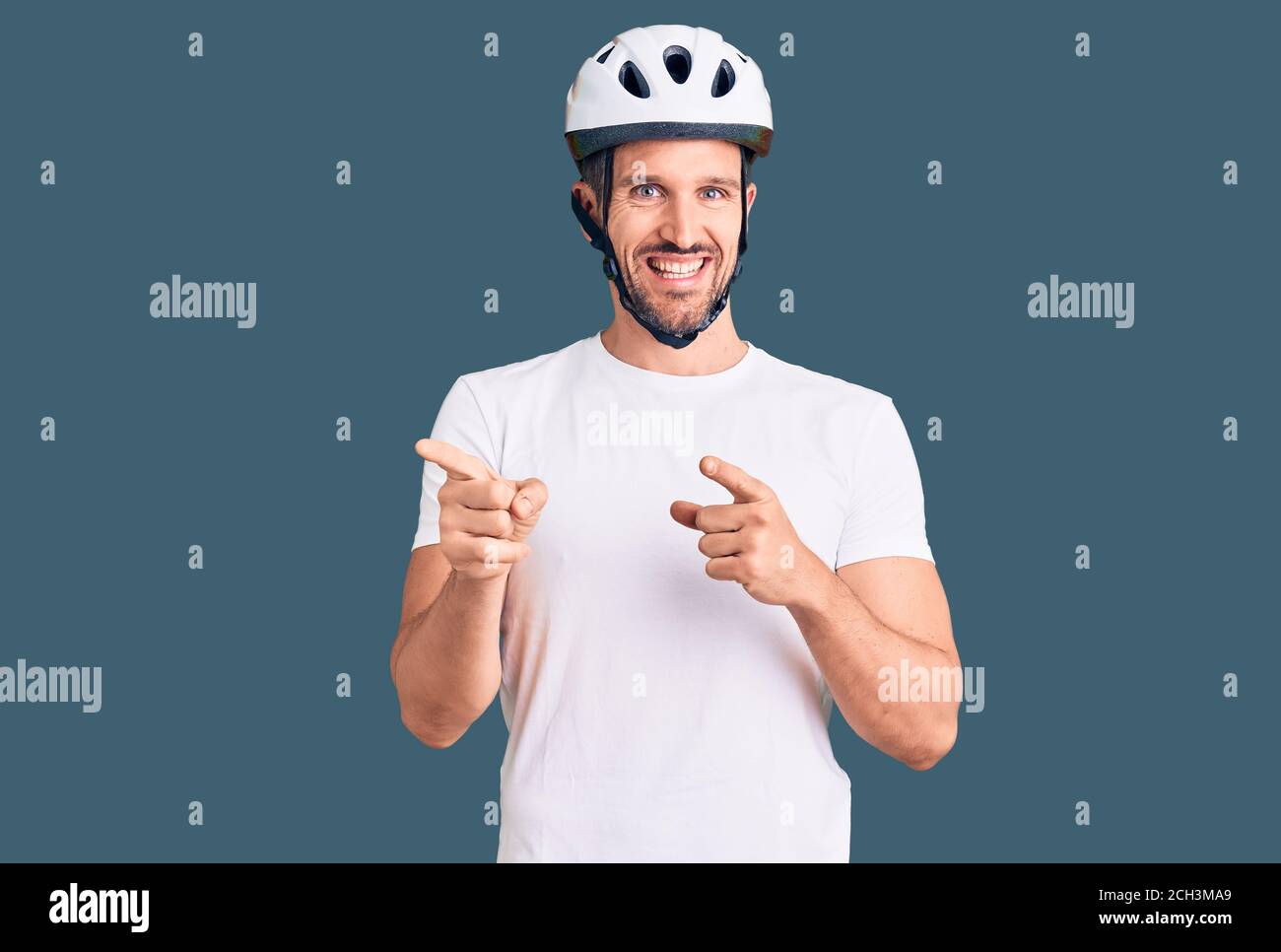 Young Handsome Man Wearing Bike Helmet Pointing Fingers To Camera With