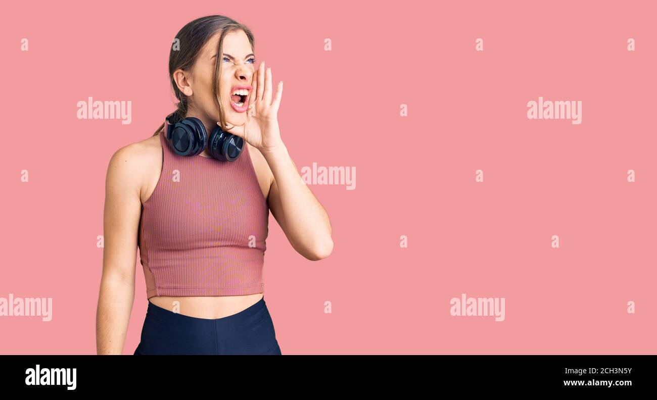 Beautiful caucasian young woman wearing gym clothes and using ...