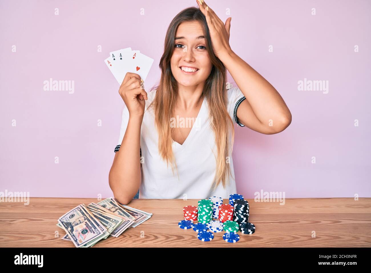 Beautiful caucasian woman playing poker holding cards stressed and ...
