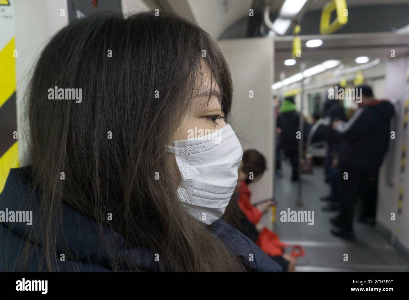 Japanese young woman wearing a hygiene protective mask over her face on ...