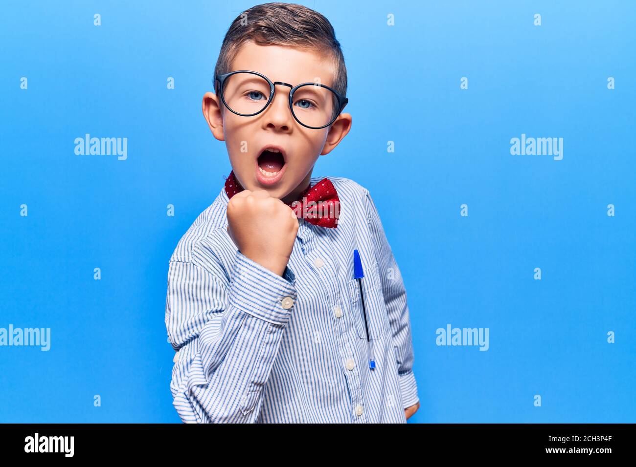 Cute blond kid wearing nerd bow tie and glasses angry and mad raising ...