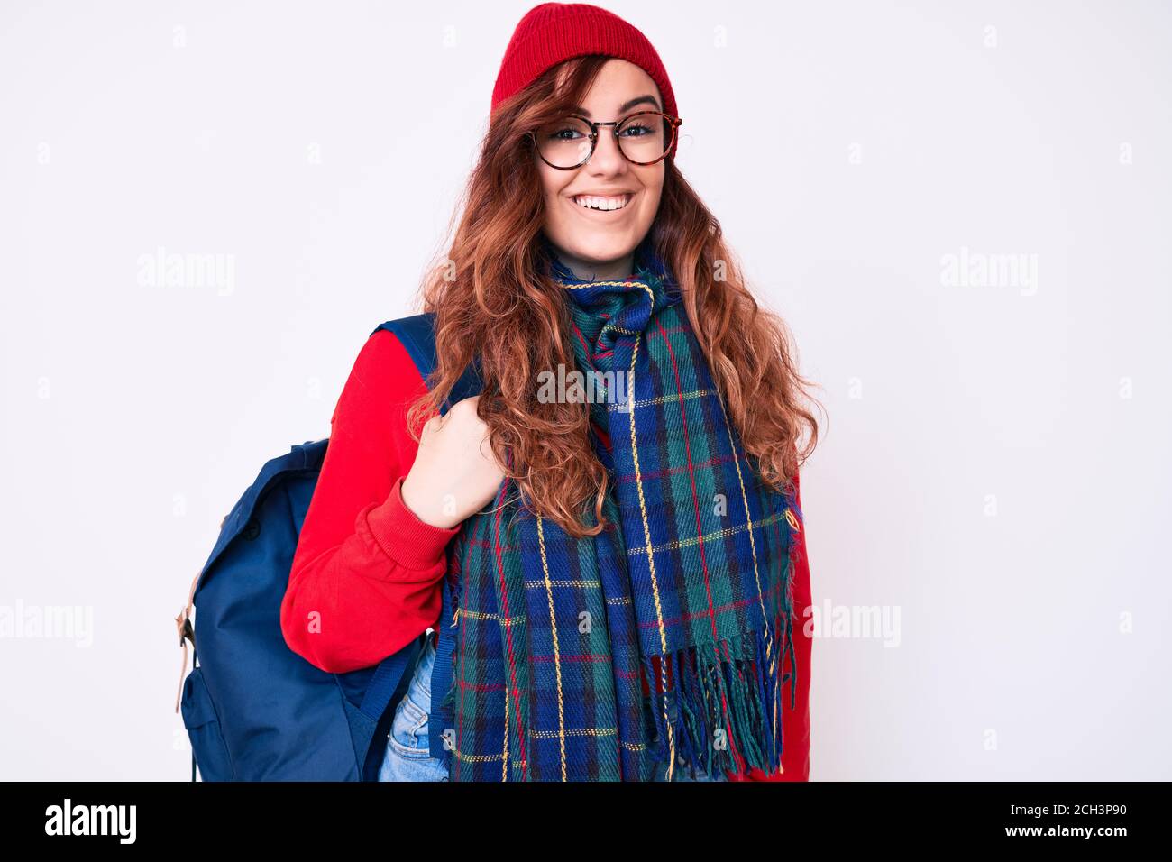 Young beautiful woman wearing winter scarf and student backpack looking ...