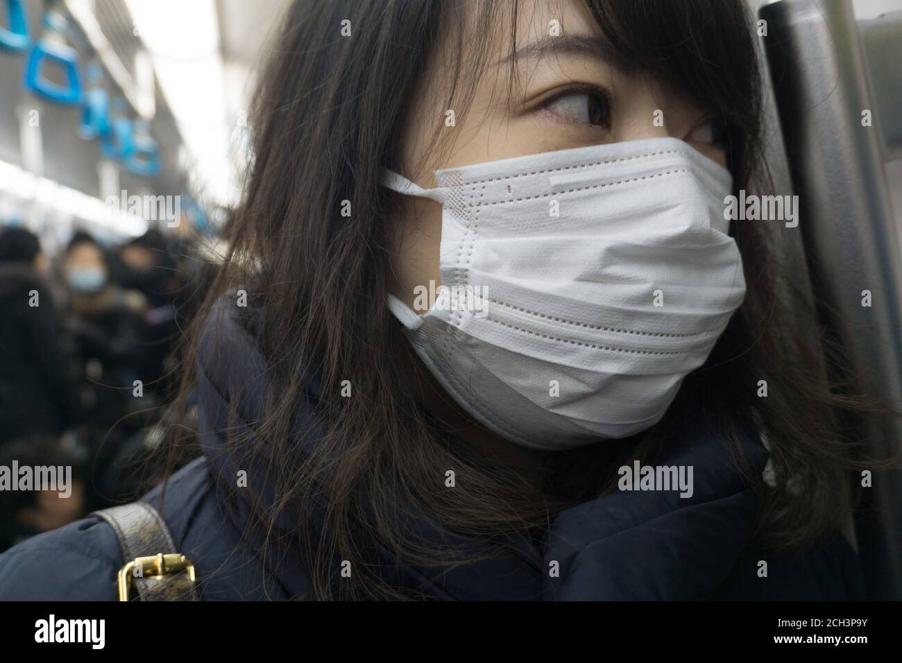 Japanese young woman wearing a hygiene protective mask over her face on ...