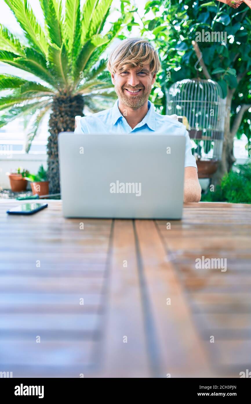 Middle age handsome man working at home using computer laptop Stock ...