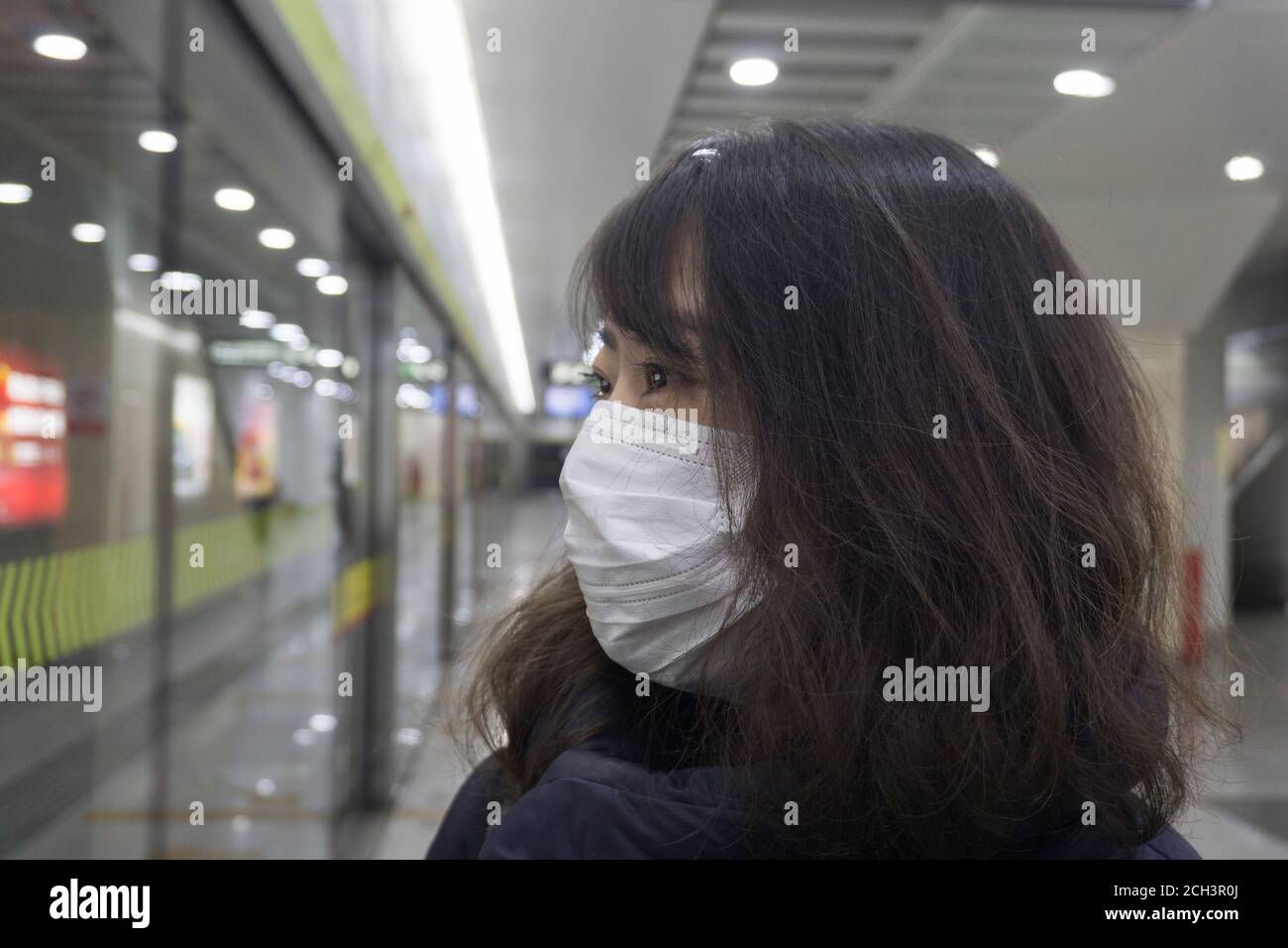 Asian young woman wearing a hygiene protective mask over her face at ...