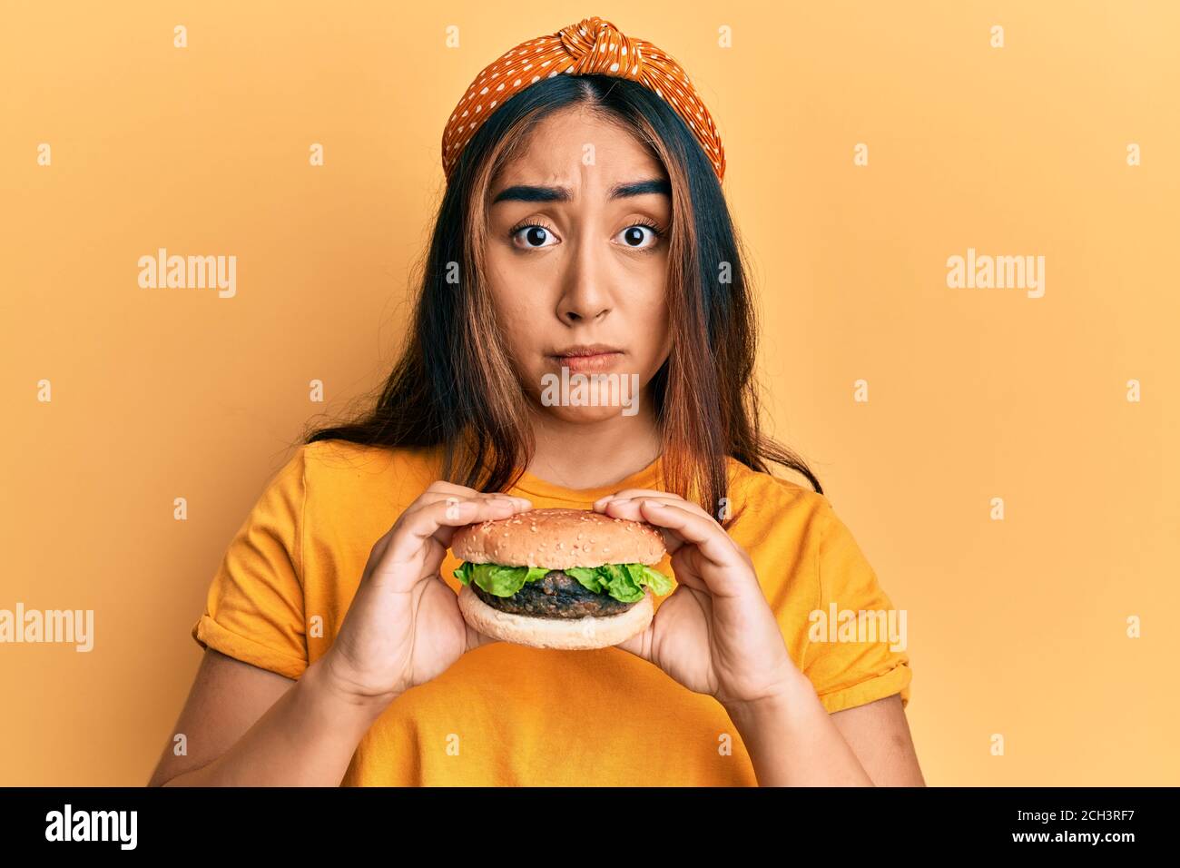Nervous person eating hamburger hi-res stock photography and images - Alamy