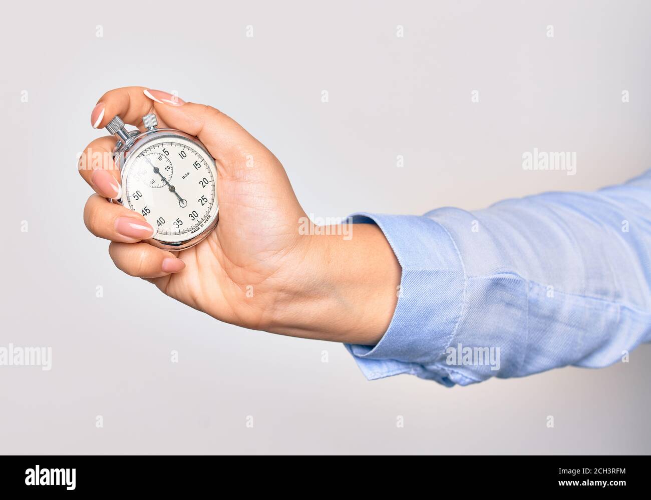 Hand of caucasian young woman counting time using stopwatch over ...