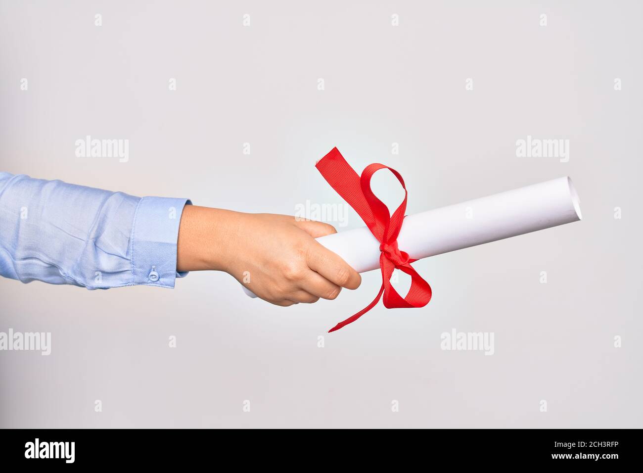 Hand of caucasian young woman holding graduated diploma degree over ...