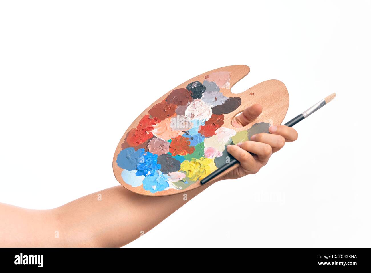 Hand of caucasian young man holding paintbrush and palette with colors ...